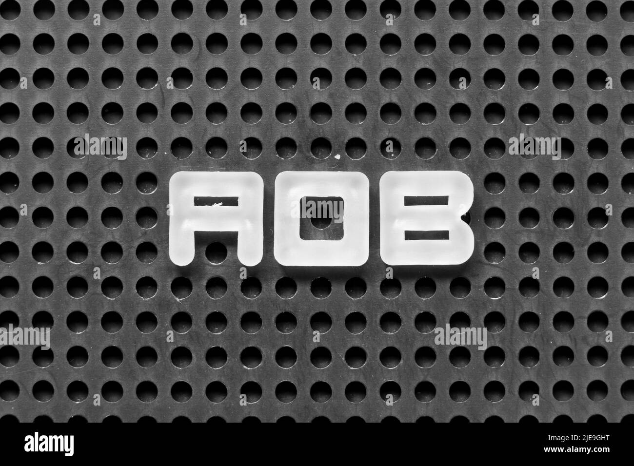 White alphabet letter in word AOB (abbreviation of Assignment of ...