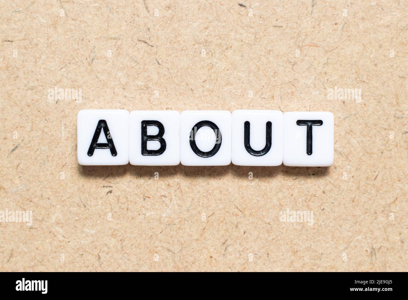 White tile alphabet letter with word about on wood background Stock ...