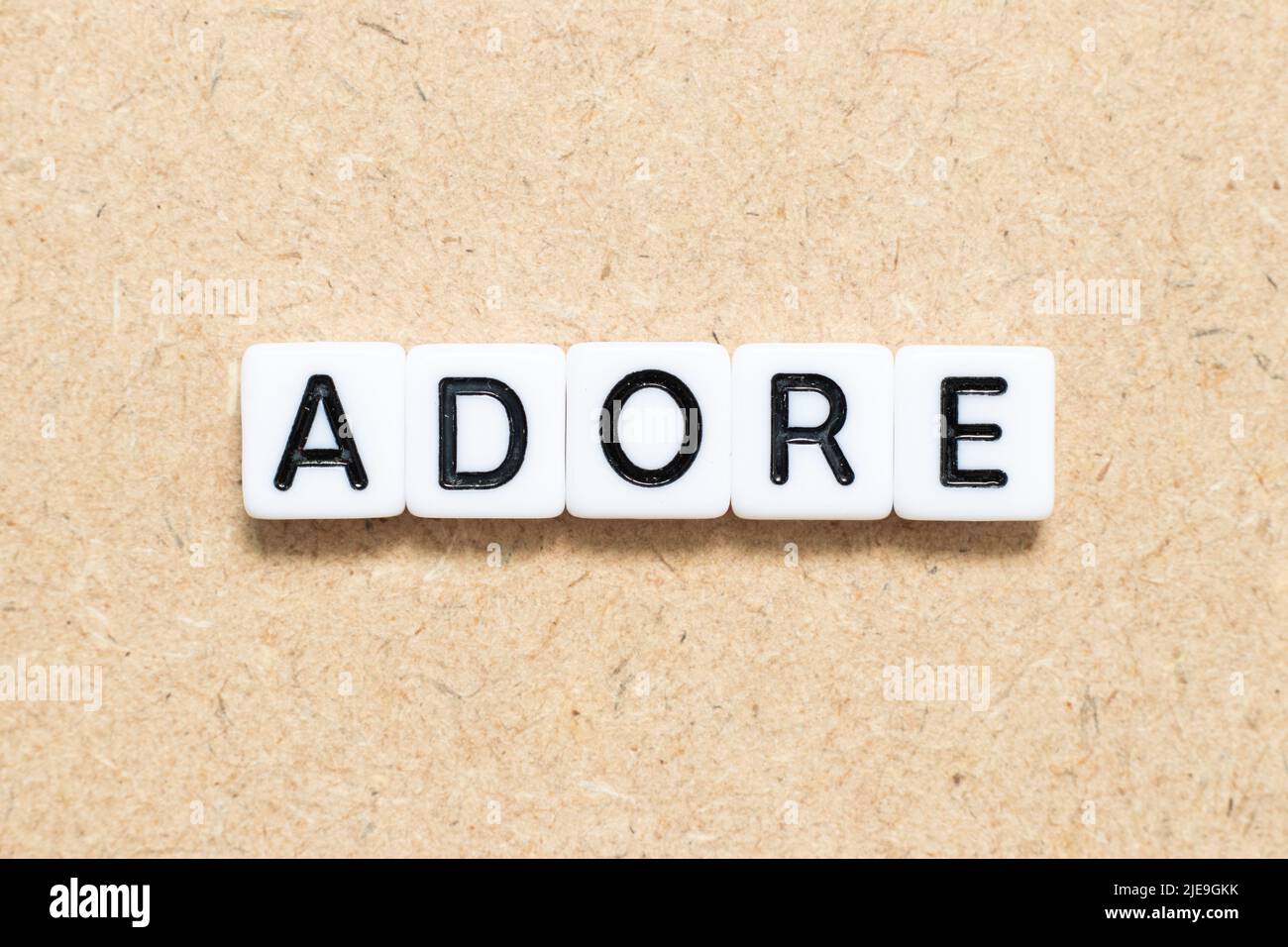 White tile alphabet letter with word adore on wood background Stock ...