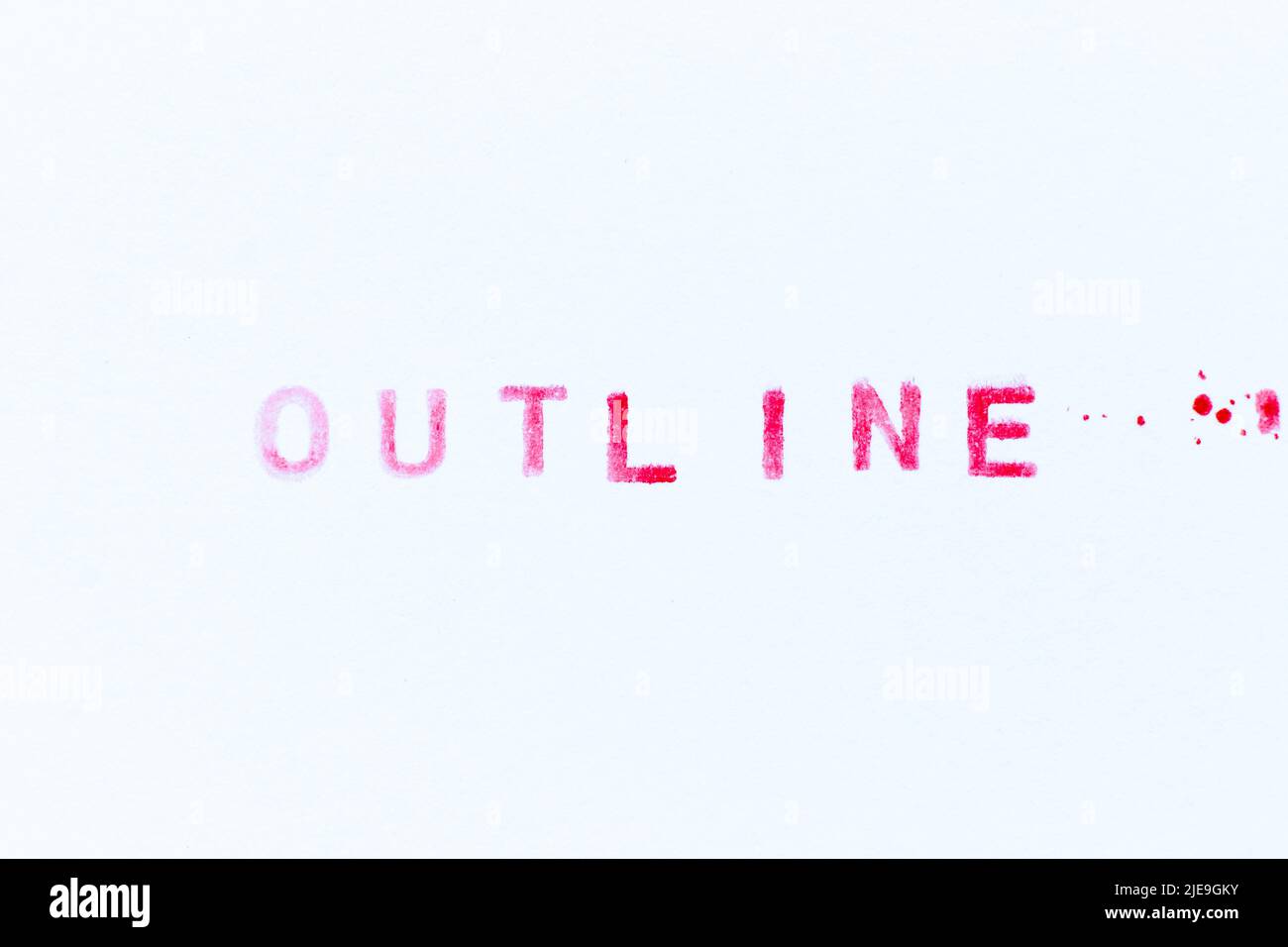 Red color ink rubber stamp in word outline on white paper background ...