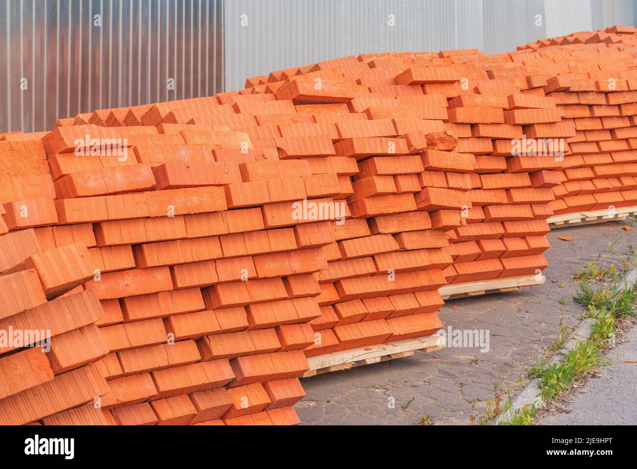 Red bricks by the construction site fence Stock Photo - Alamy