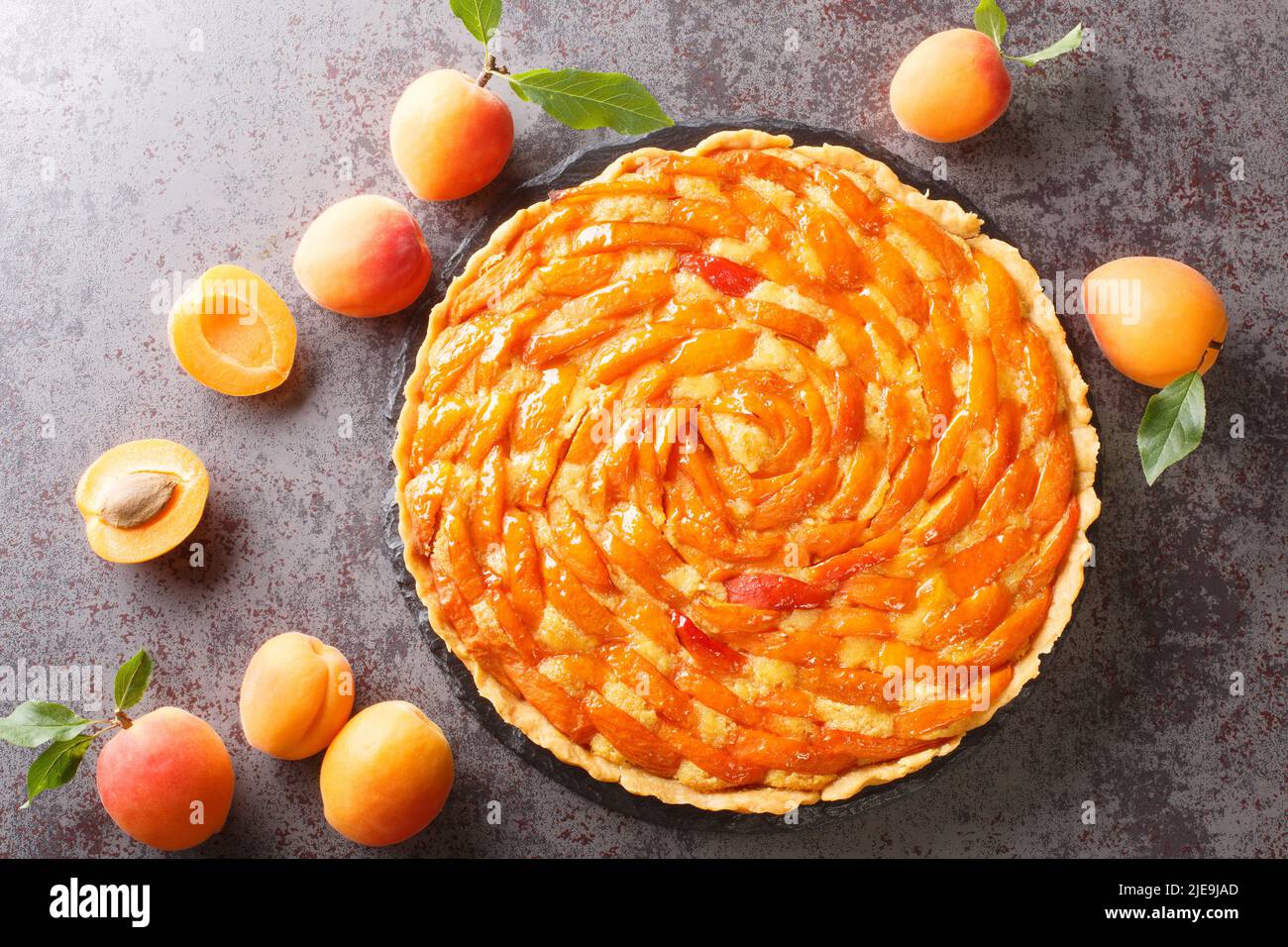 French classic dessert apricot tart with almond cream close-up on a ...