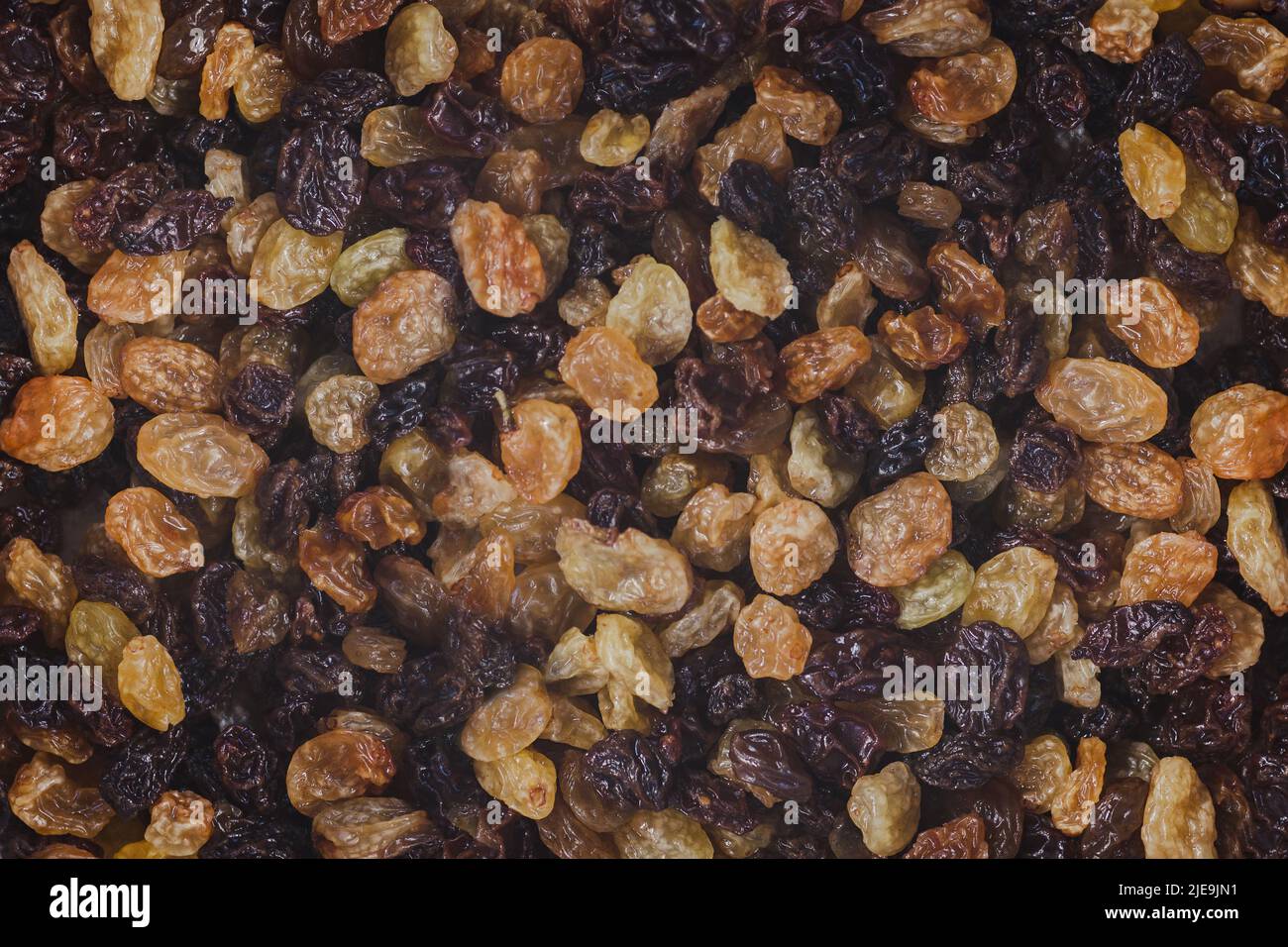light and dark dried grapes, raisins kishmish close-up macro background ...