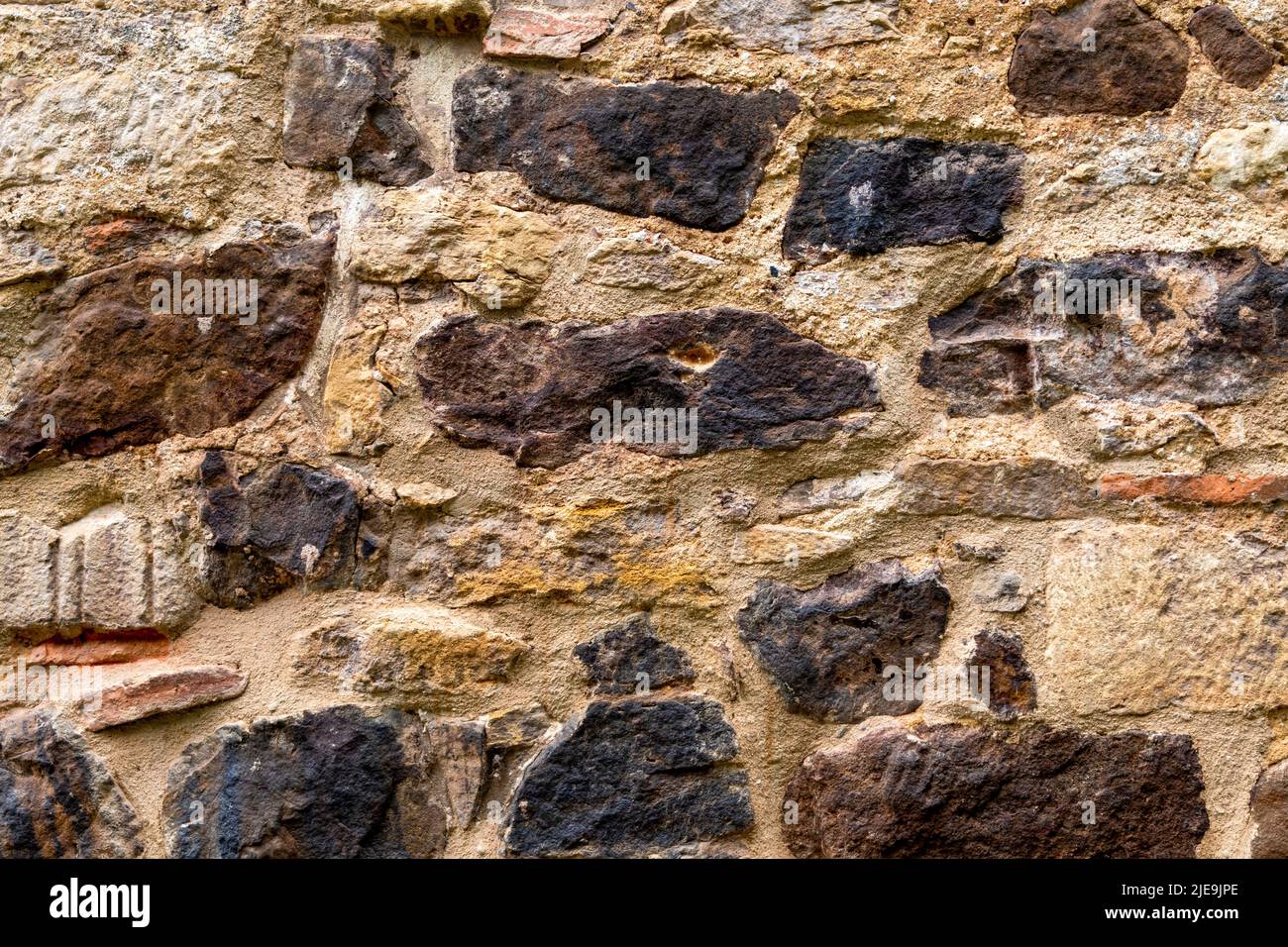 Old weathered block stone wall of a brown antique building. Grunge ...