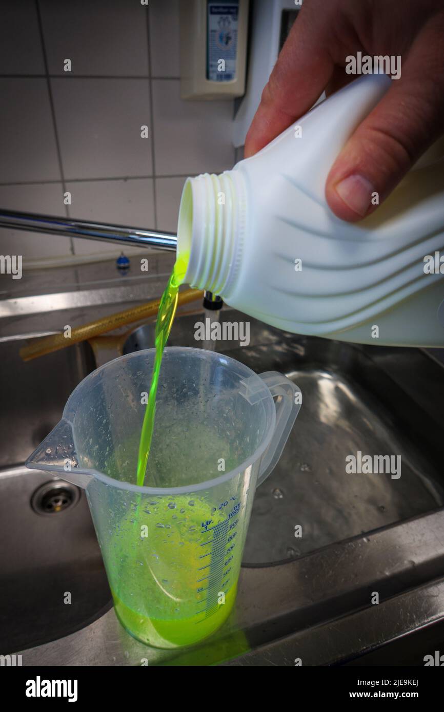 a neon green liquid is put into a water bath Stock Photo - Alamy