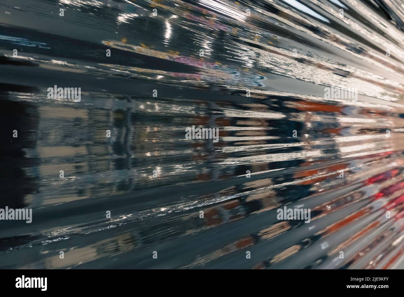 Black plastic wrap background. Crumpled wrinkled plastic cellophane ...