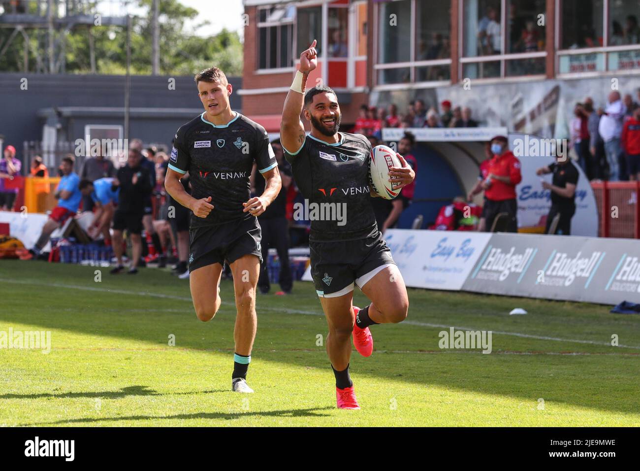 Ricky Leutele #4 of Huddersfield Giants starts to celebrate has he runs ...