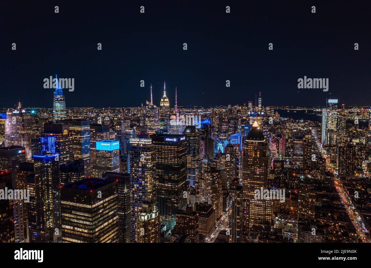Aerial panoramic shot of metropolis at night. Colourful neon lights on ...