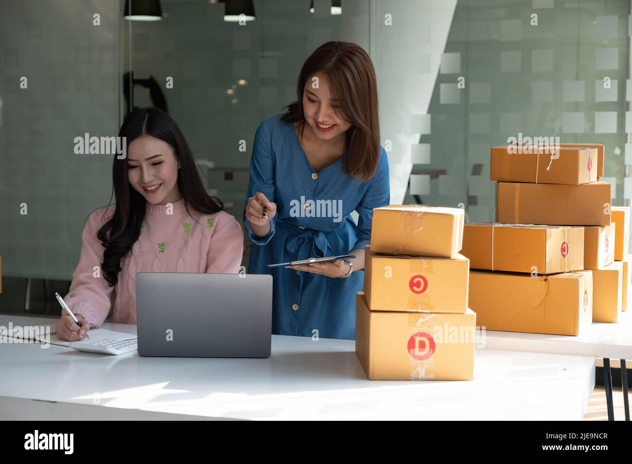 business coworkers woman online shopping working with laptop and box ...
