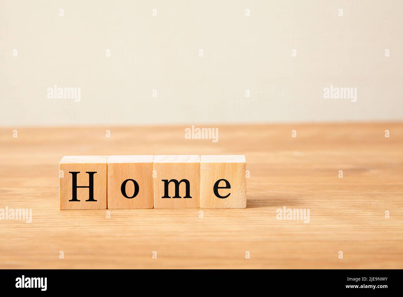 Home character. home. Written on four wooden blocks. Black letters ...