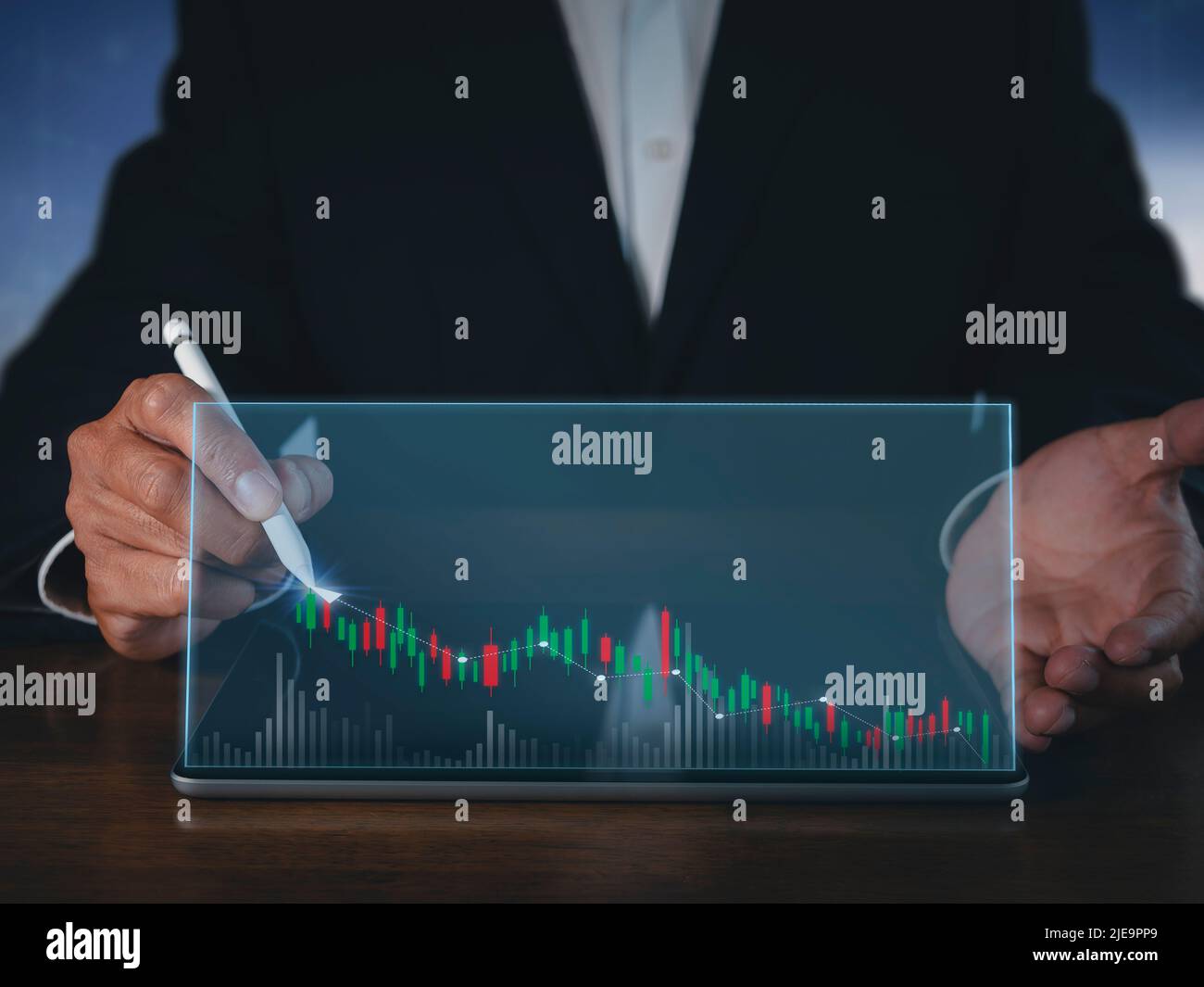 Businessman writing analyze graph for trade stock market on tablet ...