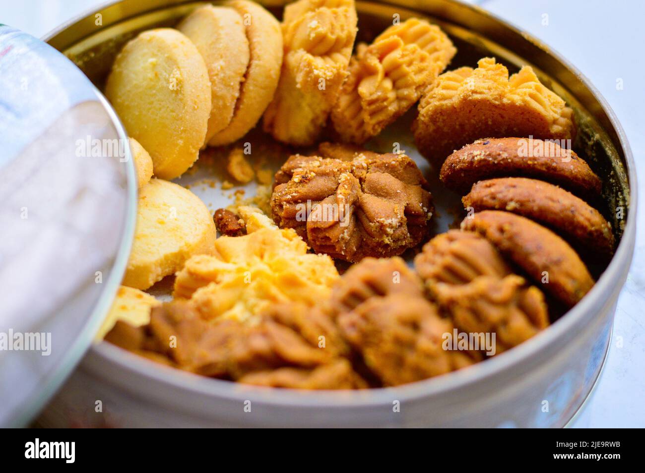 Closeup of delicious mixed flavour cookies in a round container Stock ...