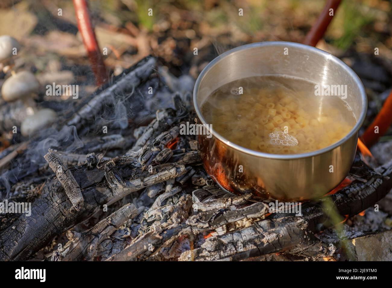 Cooking food in pot on campfire. The concept of adventure, travel ...