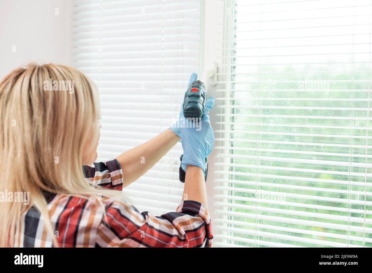 Woman with a drill. House renovation and repair concept Stock Photo - Alamy