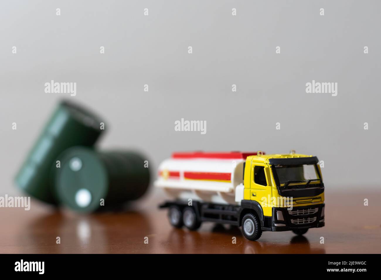 small toy combine with toy oil barrel Stock Photo - Alamy