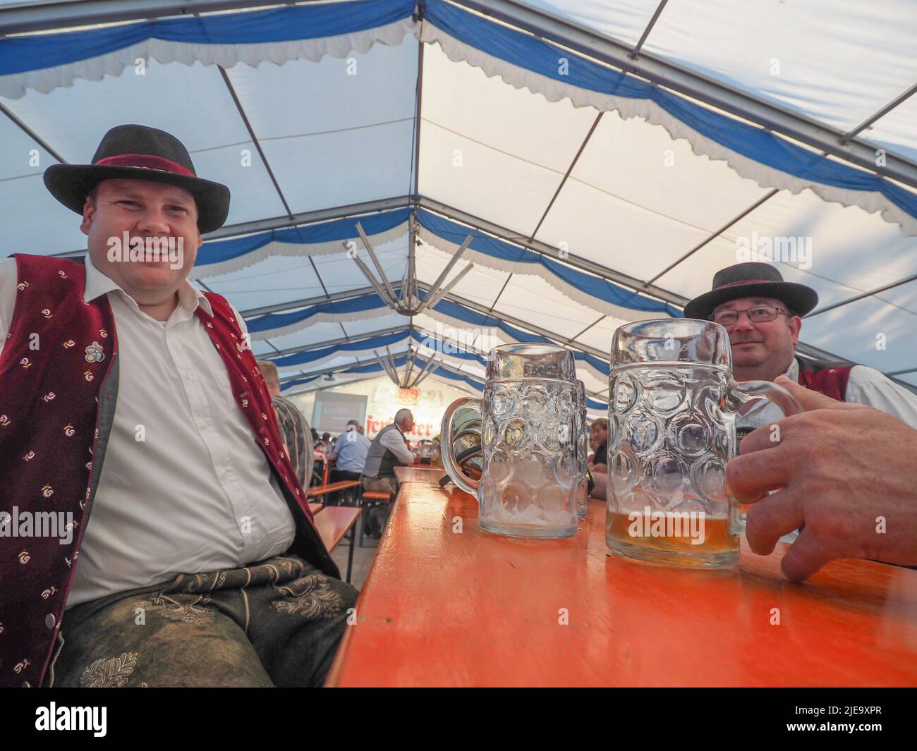 Garham, Germany. 25th June, 2022. Men in traditional clothes drink beer ...