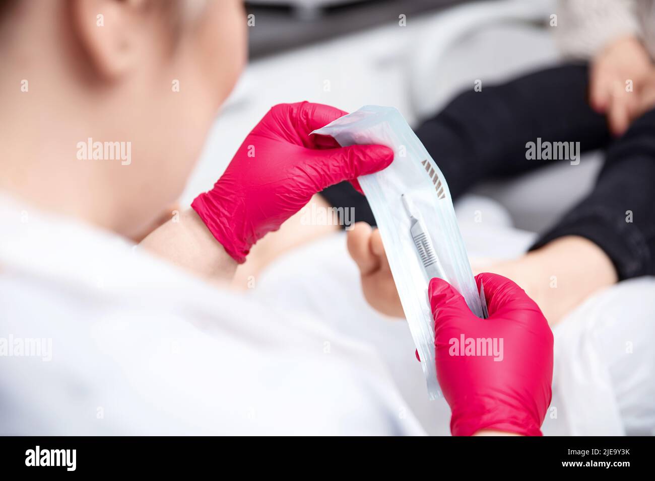 Chiropodists unpacks a scalpel blade from the sterile packaging Stock ...