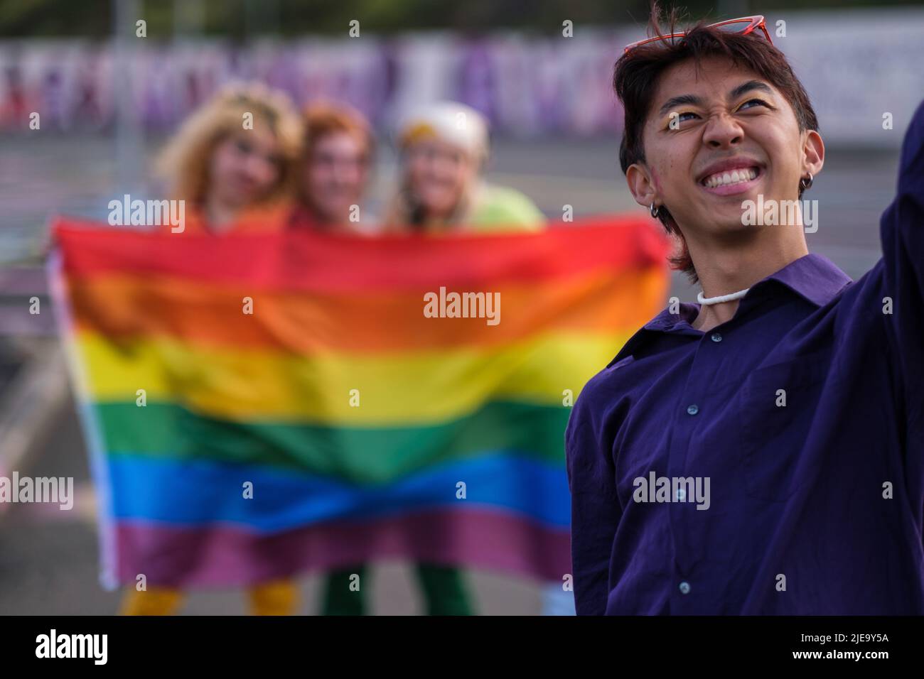 Young guy taking a selfie and behind his friends out of focus with the ...