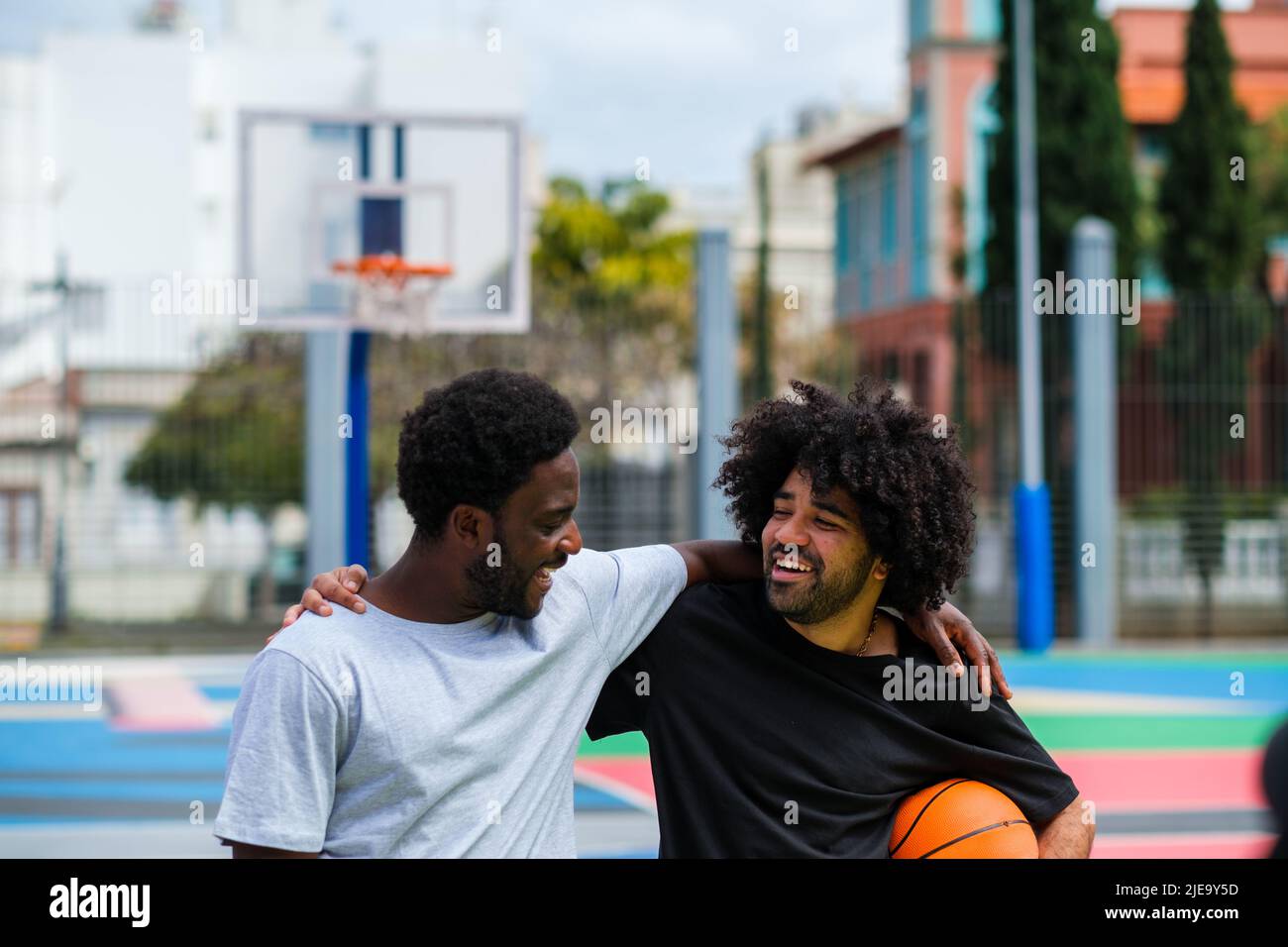 Two young friends playing basketball hi-res stock photography and ...