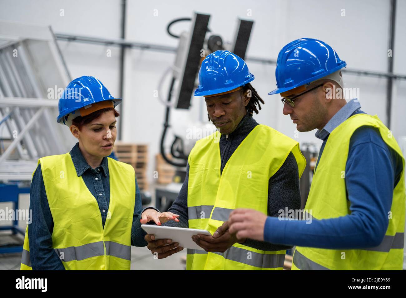 Three co-workers interacting to improve the operation of the factory ...