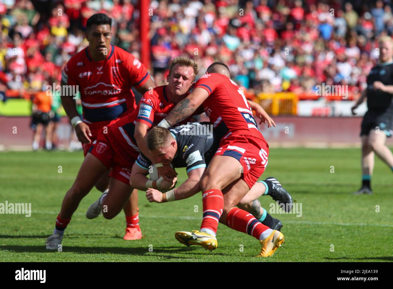 Luke Yates #13 of Huddersfield Giants is stopped by the Hull KR defence ...