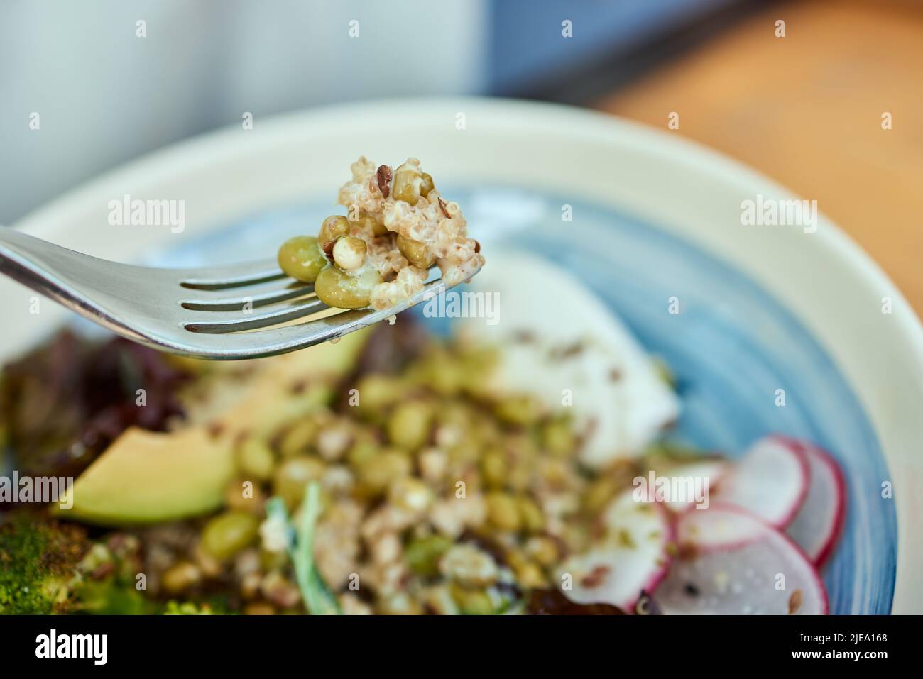 Woman eating quinoa broccoli salad. Eat healthy food lifestyle concept ...
