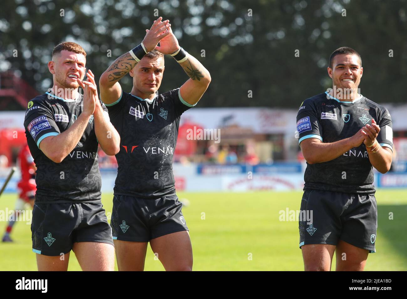 Oliver Russell #23, Danny Levi #9 and Tui Lolohea #6 of Huddersfield ...