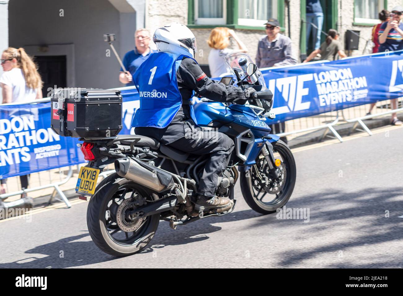 Rolling road block motorcycle rider riding the road race course through ...