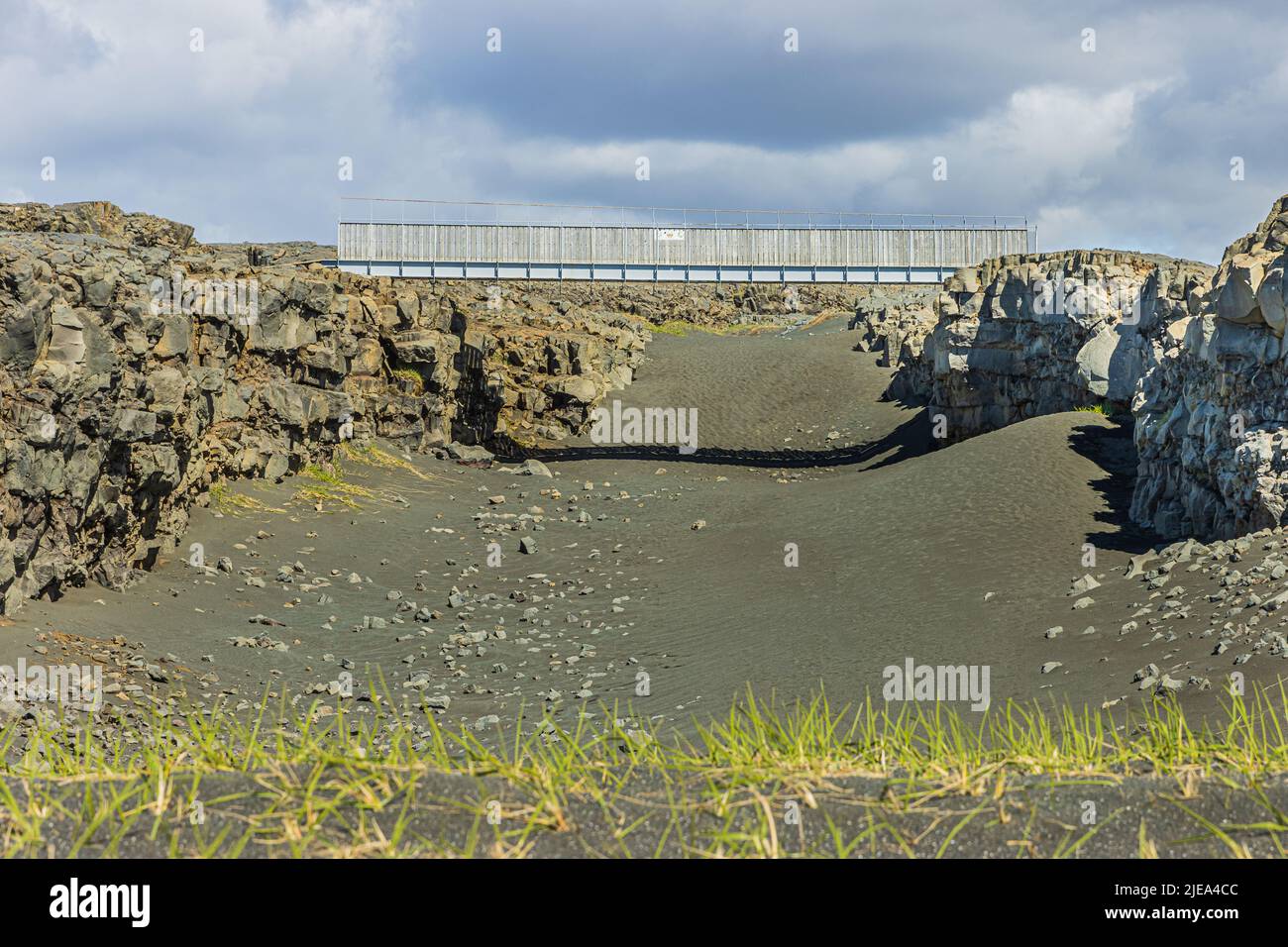 Landscape in sunshine on Reykjanes Peninsula of Iceland. Metal bridge ...