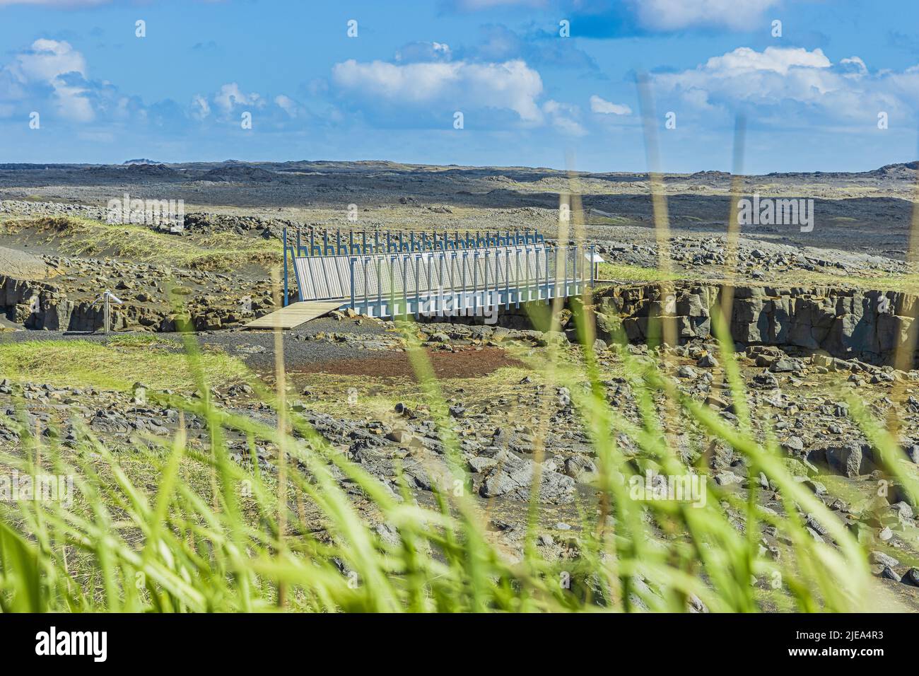 Metal bridge over the American and Eurasian tectonic plates in sunshine ...