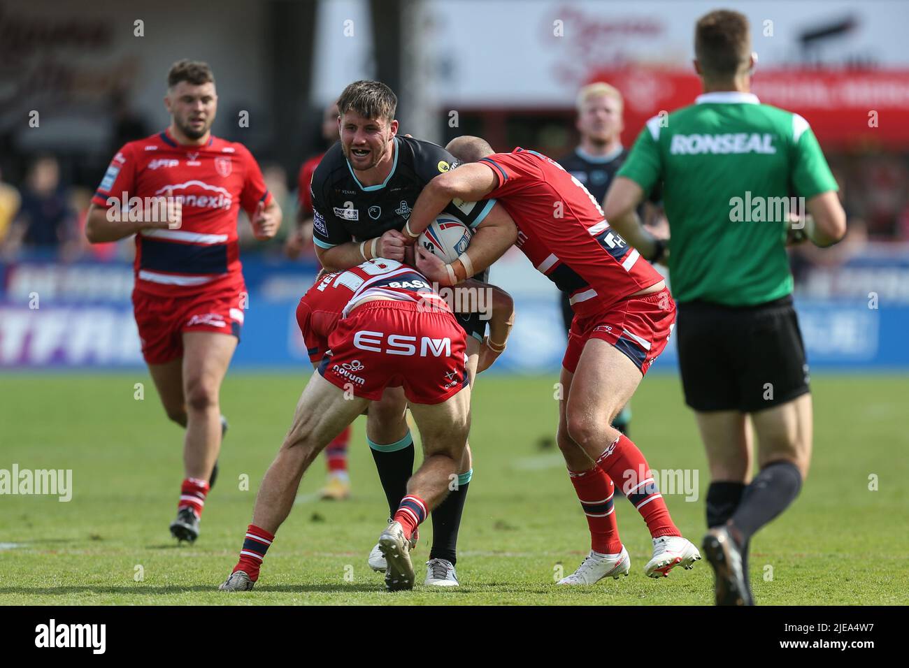 Joe Greenwood #15 of Huddersfield Giants is stopped by Jimmy Keinhorst ...