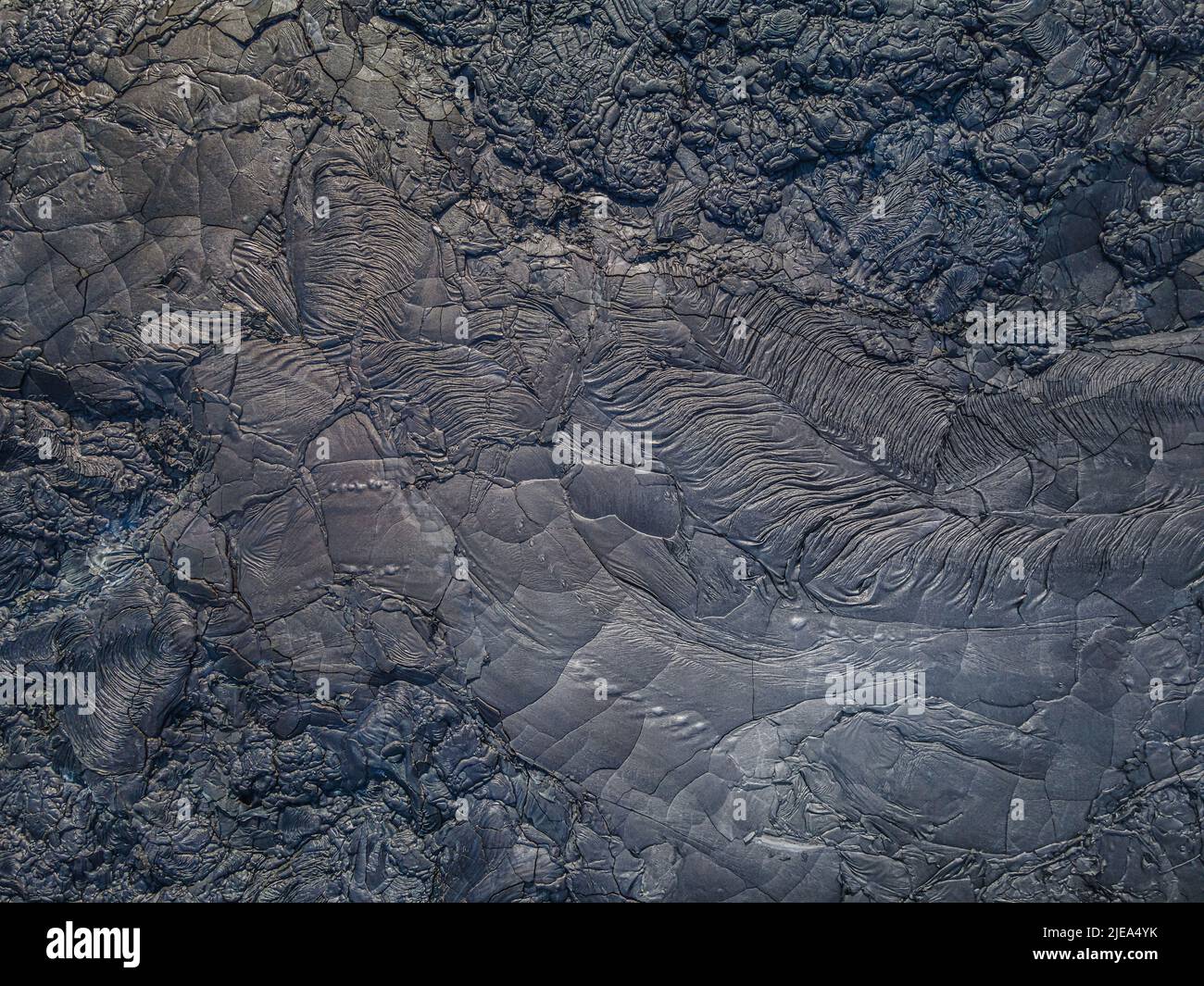 Top view of solidified lava. Dark colored structures from lava flow ...