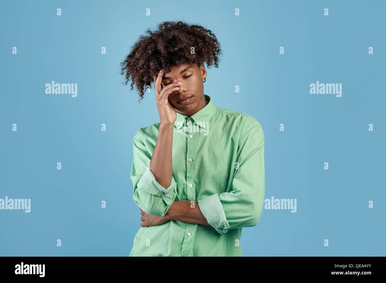 Portrait of bored black guy leaning on palm and closing eyes, being ...