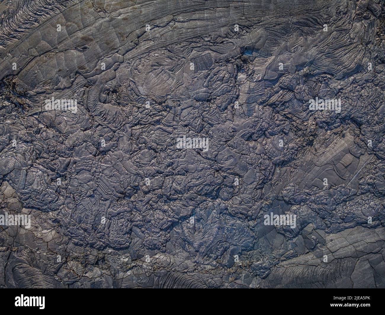 Lava field from above. Cooled lava flow with structures in dark color ...
