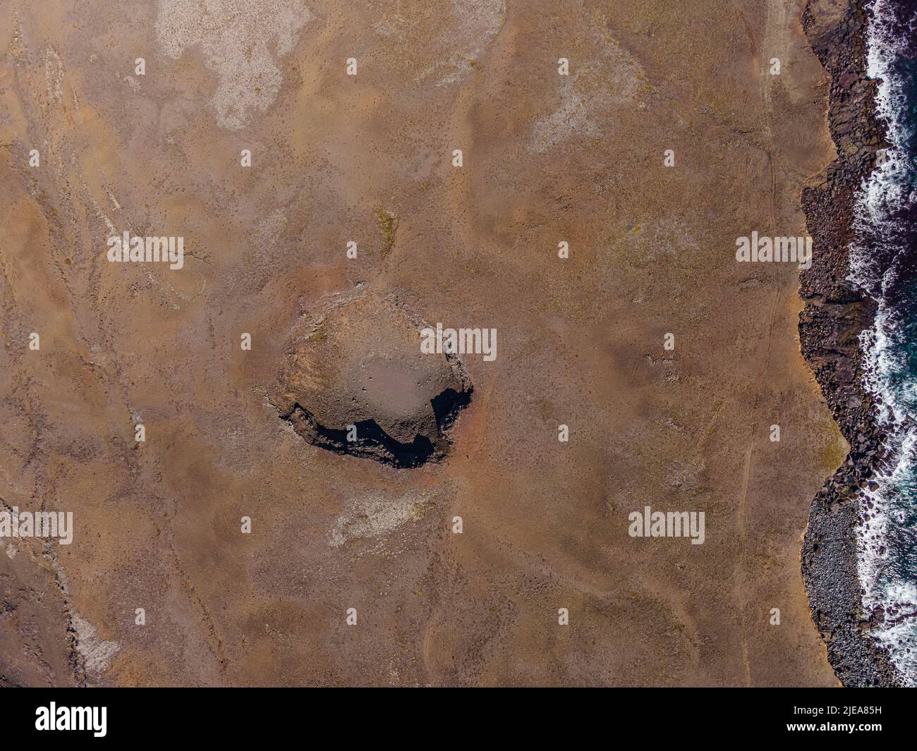 Top view on landscape of Iceland. Old crater on brown sand surface on ...