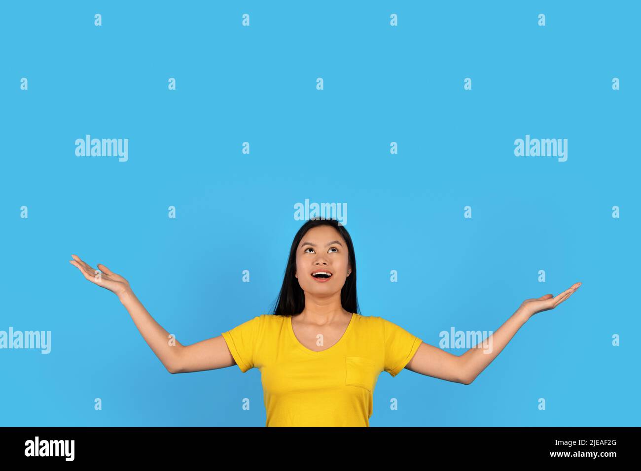 Glad surprised young korean female with down syndrome in yellow t-shirt ...