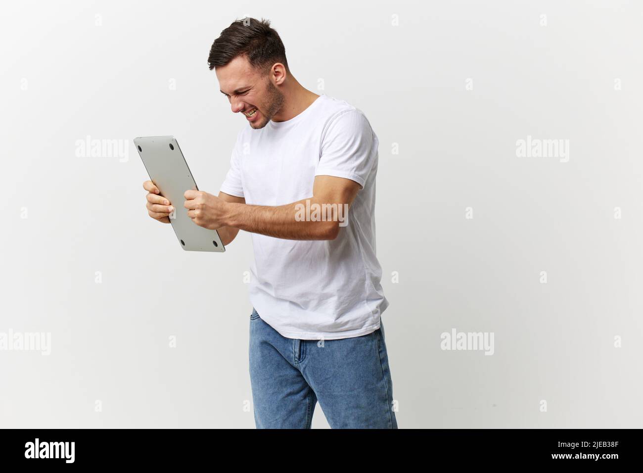 Aggressive angry crazy tanned handsome man in basic t-shirt scream at ...