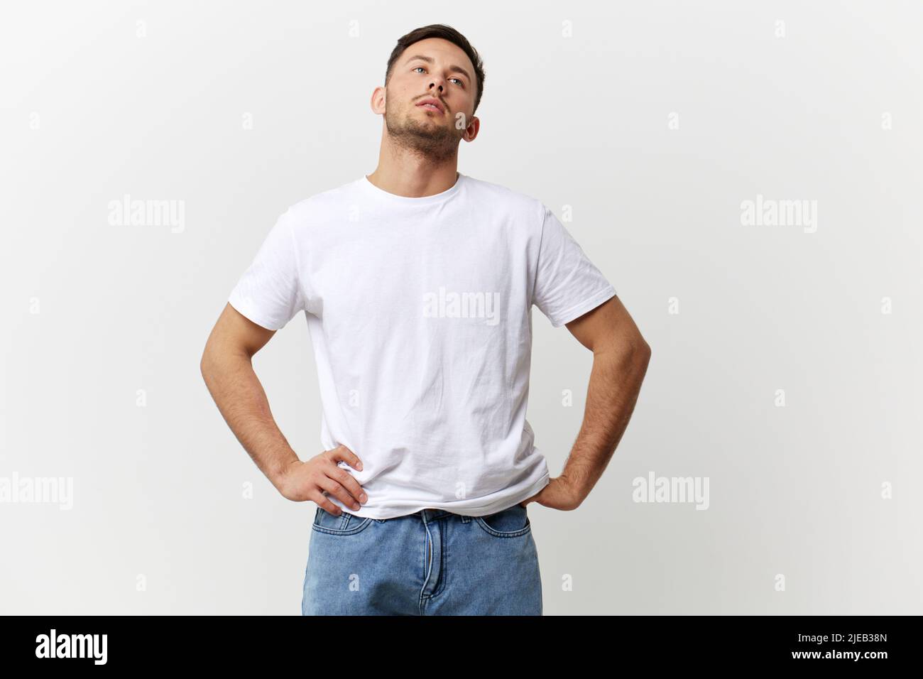 Tired frustrated tanned handsome man in basic t-shirt think about ...