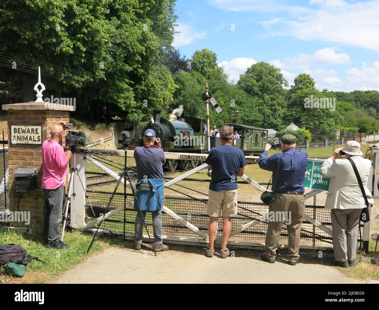 Cameras at the ready, a line of men wait at the crossing to photograph ...