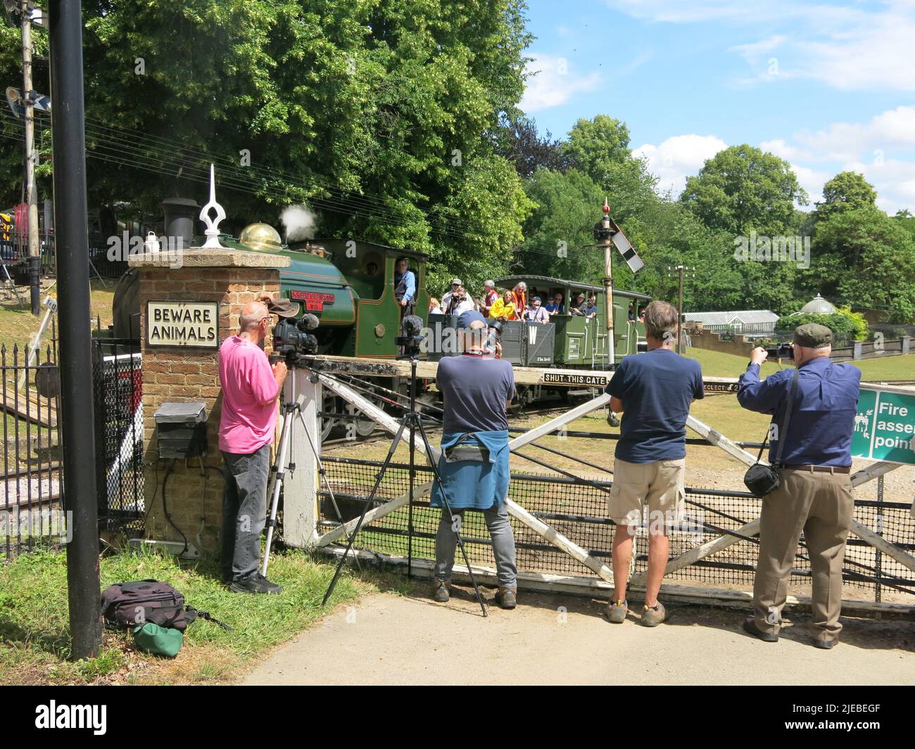 Cameras at the ready, a line of men wait at the crossing to photograph ...