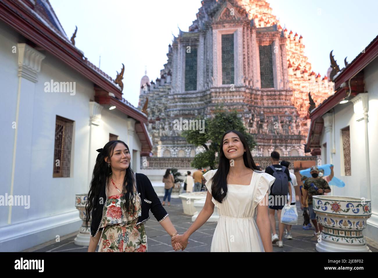 Two relaxed friends visiting an ancient buddhist temple Stock Photo - Alamy