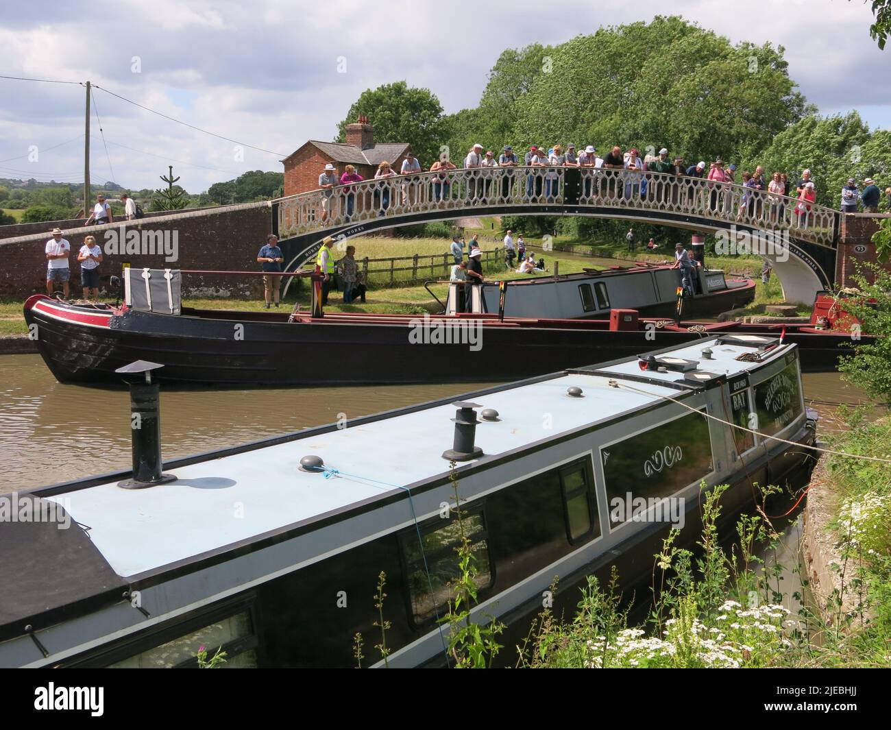 Crowds gather on the bridge to watch the parade of historic working ...
