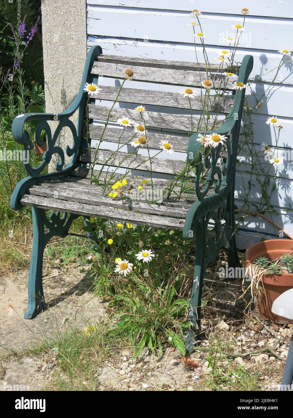 A rustic, vintage garden seat made from green painted lattice ironwork ...