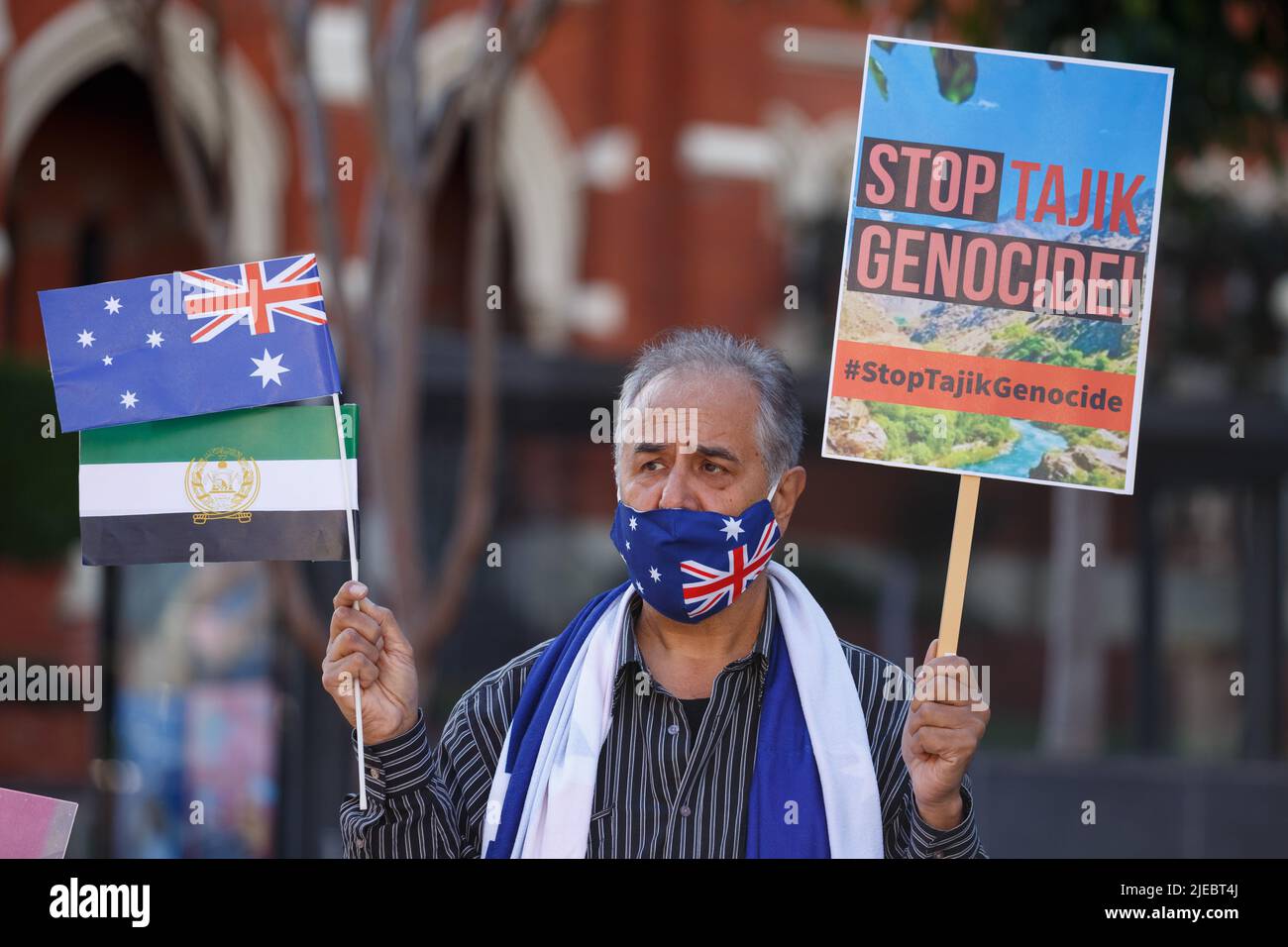 A protester holds flags and a placard expressing his opinion during the ...
