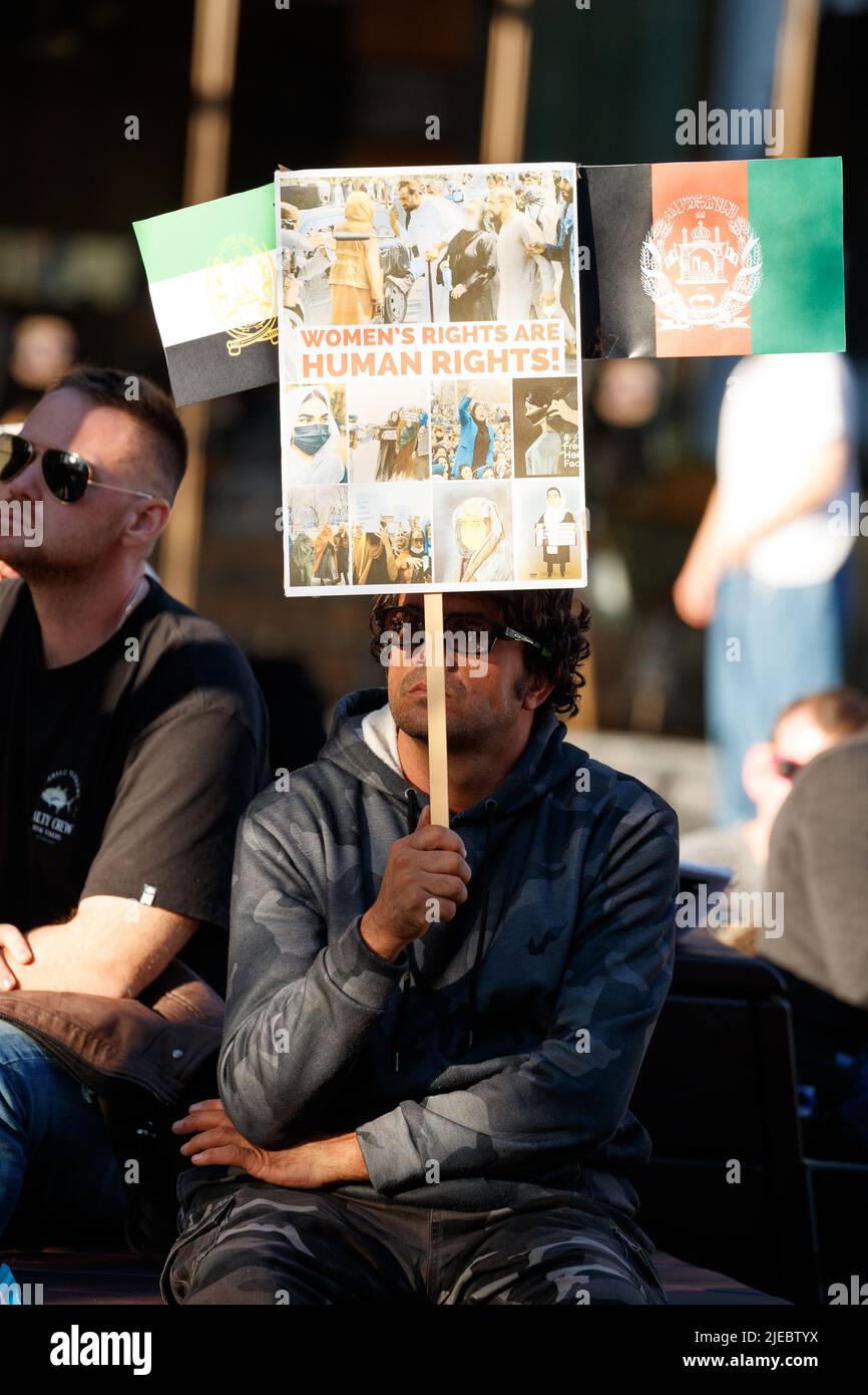 A protester holds a placard expressing his opinion during the rally in ...