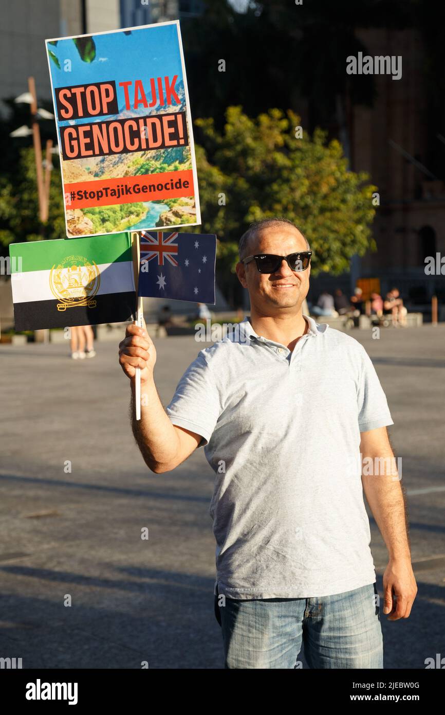 A protester holds flags and a placard expressing his opinion during the ...