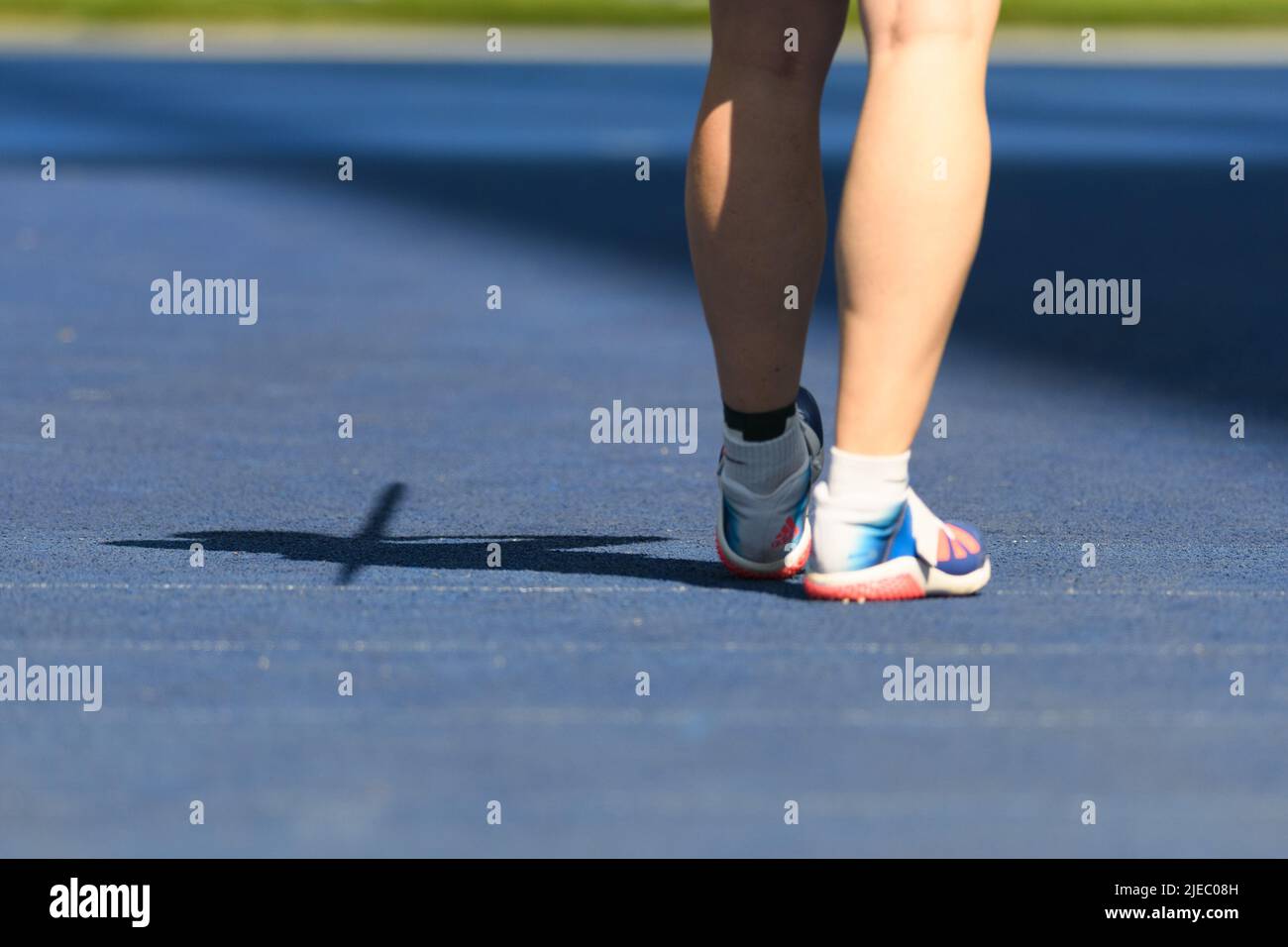 Javelin thrower is throwing a shadow on the turf during the 2022 ...