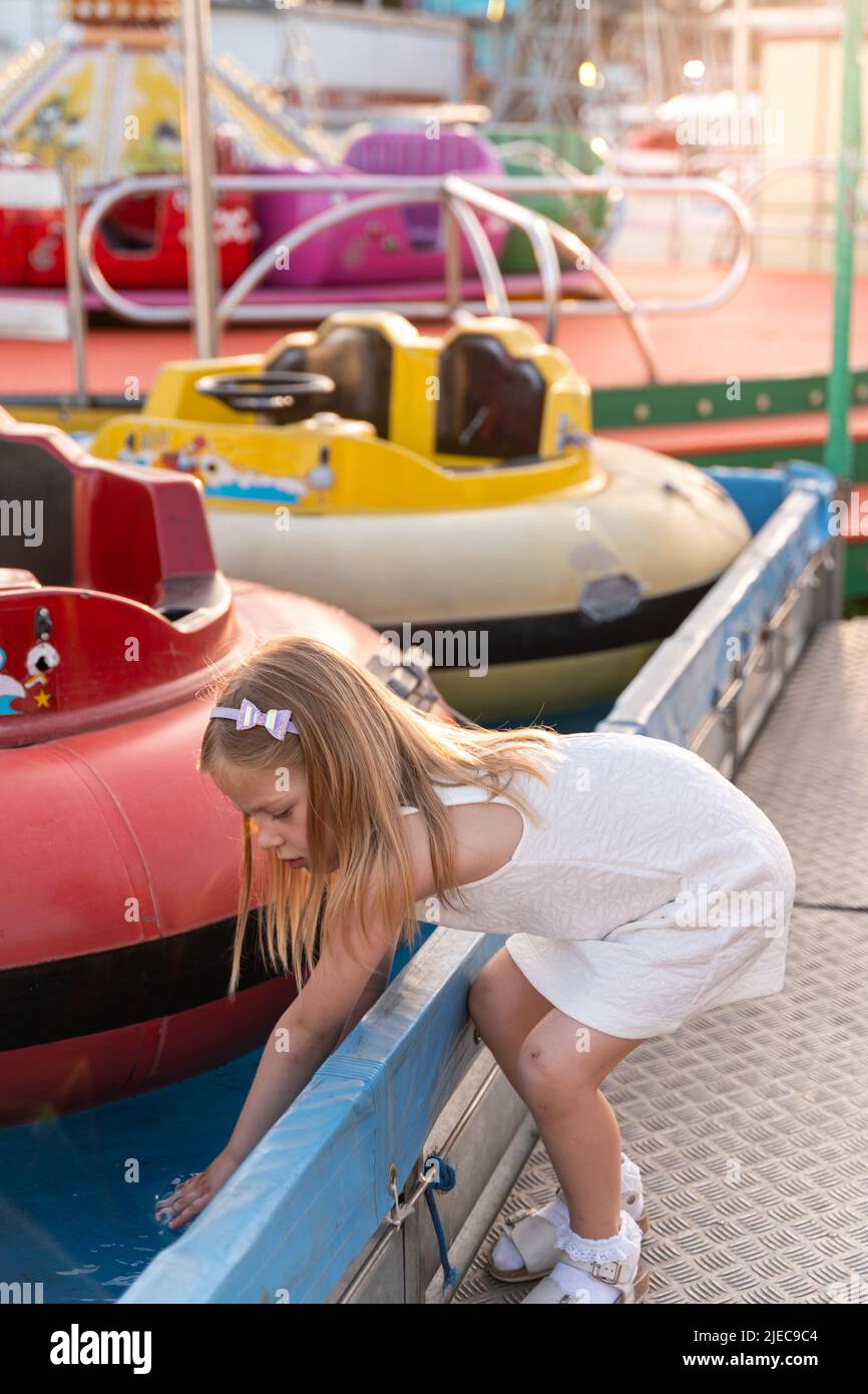 blonde happy little girls having fun at the amusement park - summer fun concept Stock Photo - Alamy