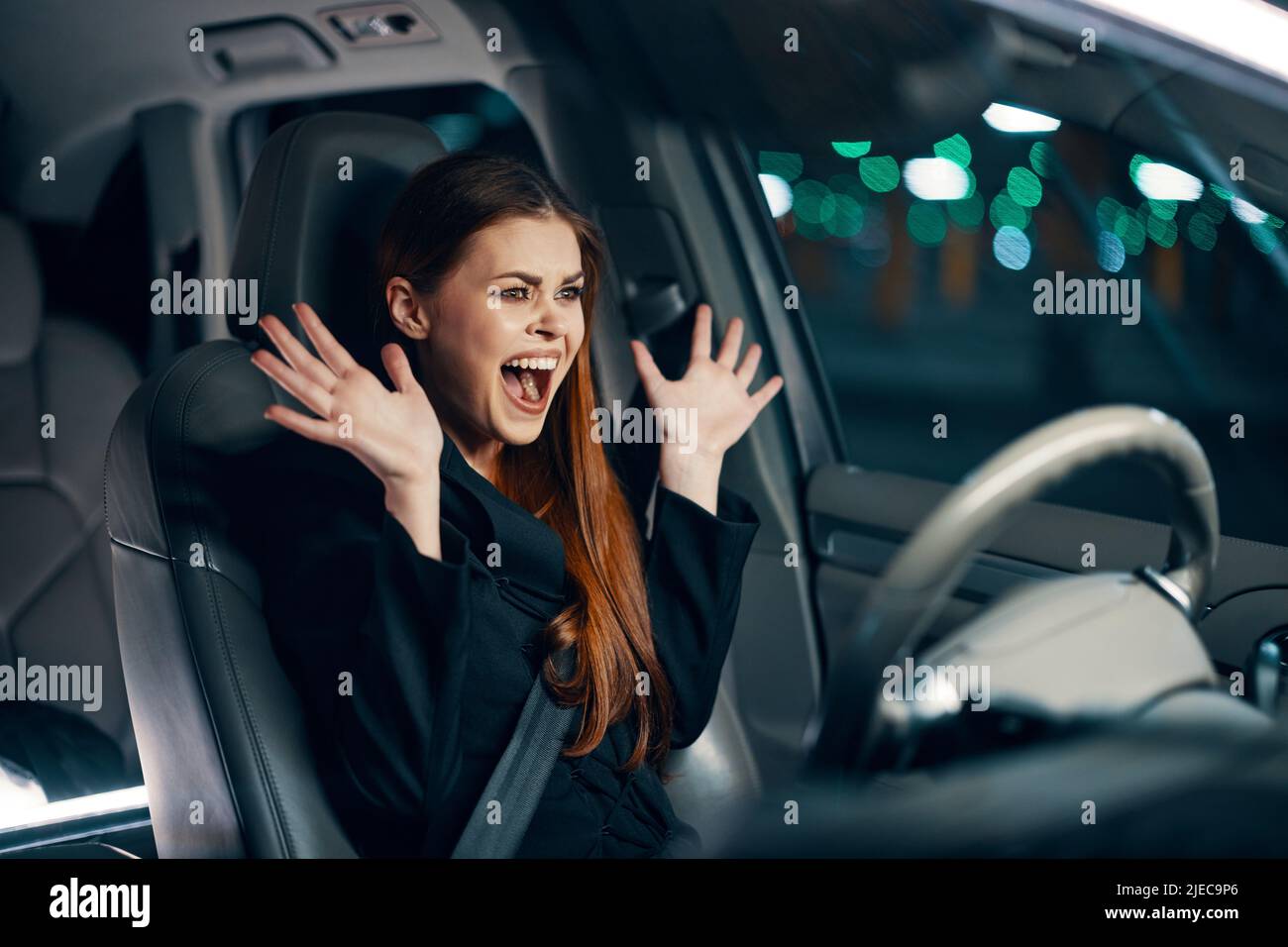 An Emotional Frightened Woman Is Sitting Behind The Wheel Of A Car In A Black Shirt Wearing A