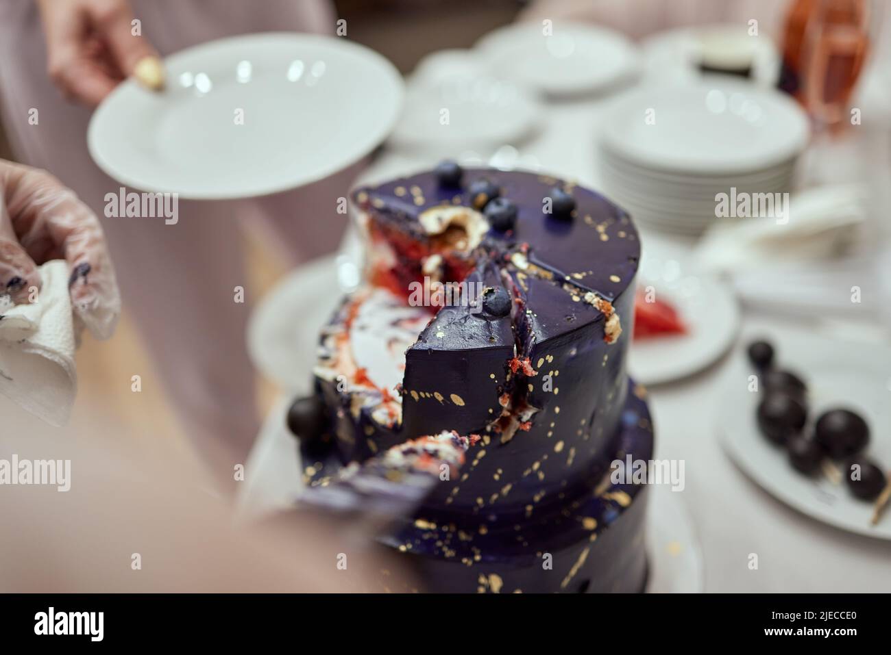 Black bunk cake on the dark black background with golden stars and ...